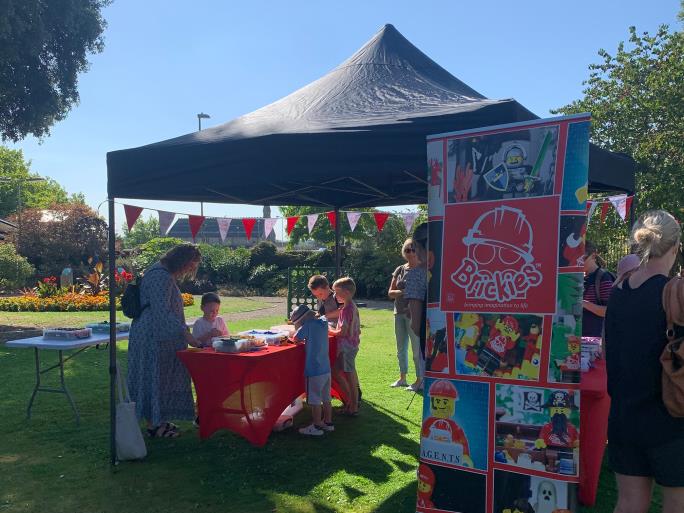 Photo of families under Lego building gazebo